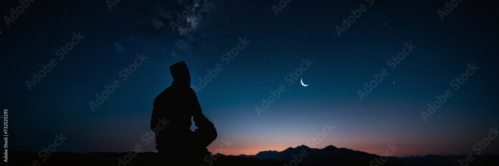 Panoramic banner with silhouette of praying Muslim man in traditional ...