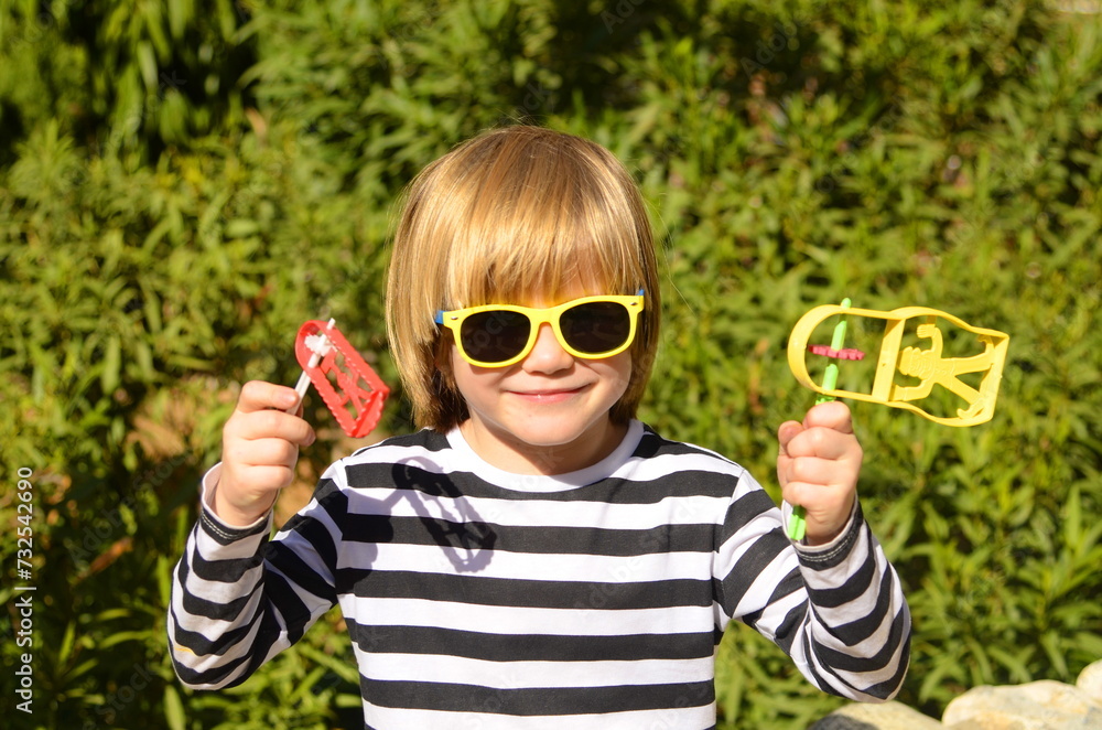Purim. A child with a grager and ratchet celebrates the Jewish joyful ...