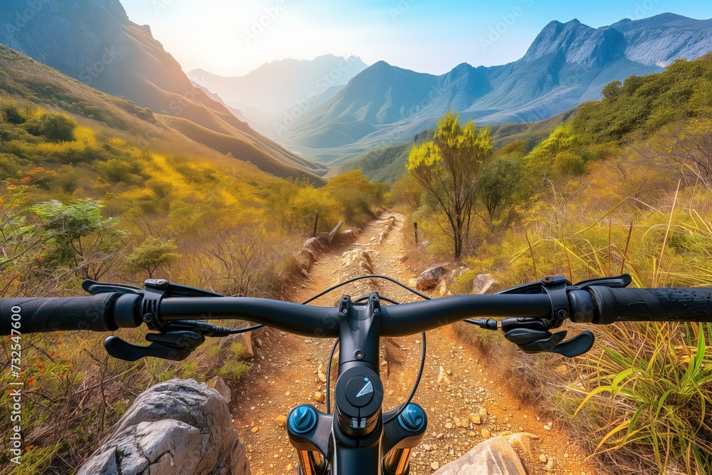 Biker’s view navigating rocky mountain trail, golden hour illuminates ...