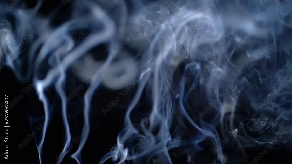 Thin Curls of Blue Smoke Rise Up, Fill Empty Space on a Black ...
