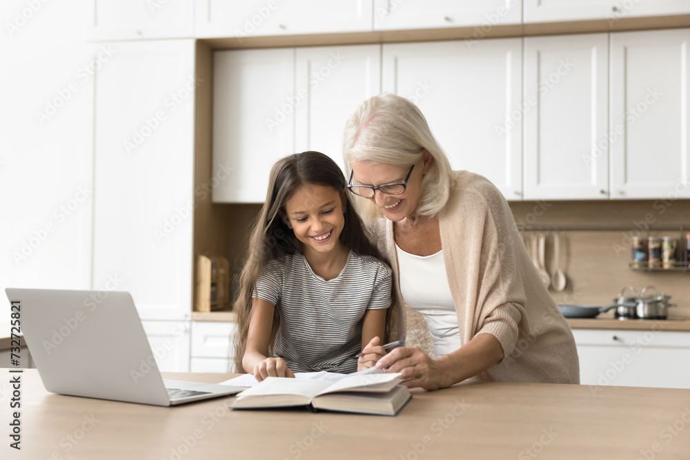 Happy grandma helping adorable preteen granddaughter schoolkid with ...