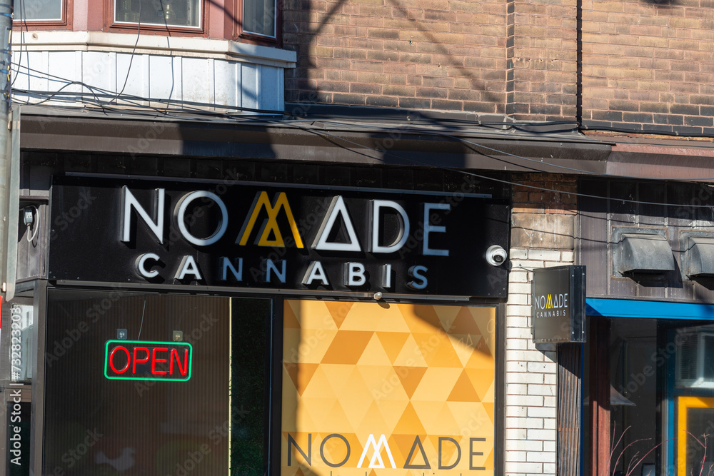 exterior building facade window display and sign of Nomade Cannabis ...
