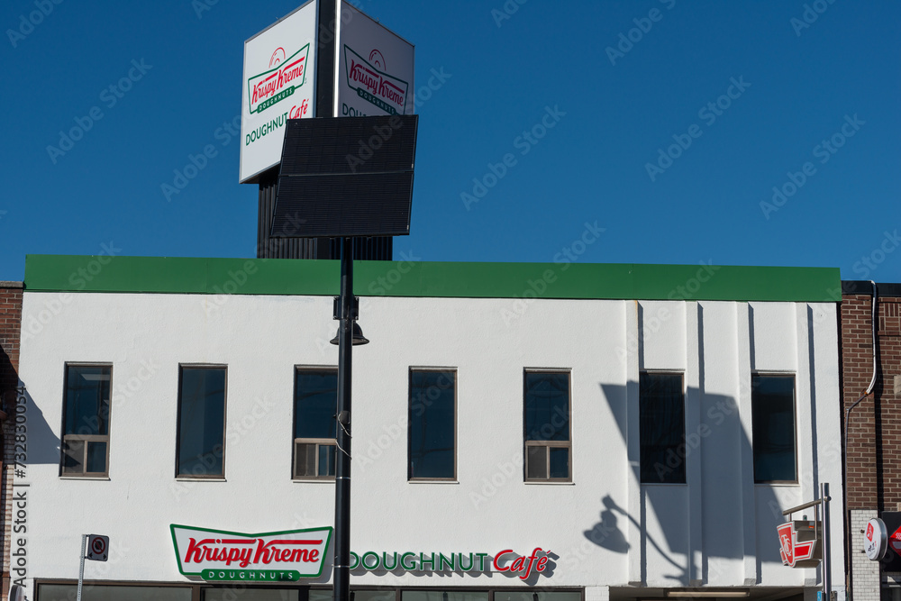 exterior building facade and signs of Krispy Kreme Café, a chain donut ...