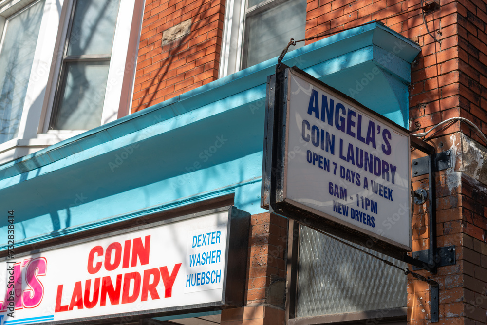 exterior building facade and projecting sign of Angela's Coin Laundry ...