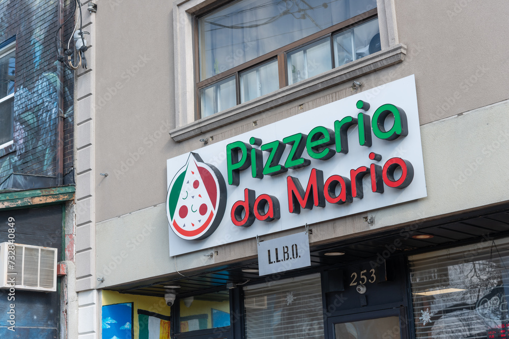 exterior building facade and sign of Pizzeria da Mario, a pizza ...