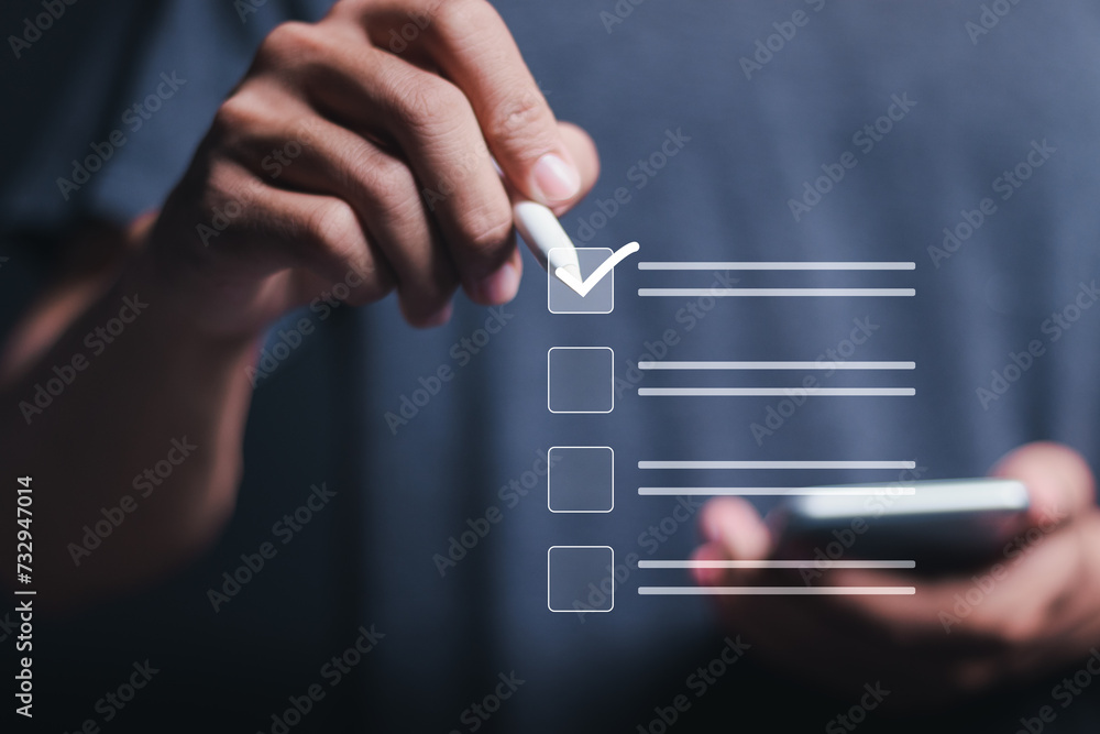 Checklist concept. Person use smartphone to checking mark on checkboxes ...