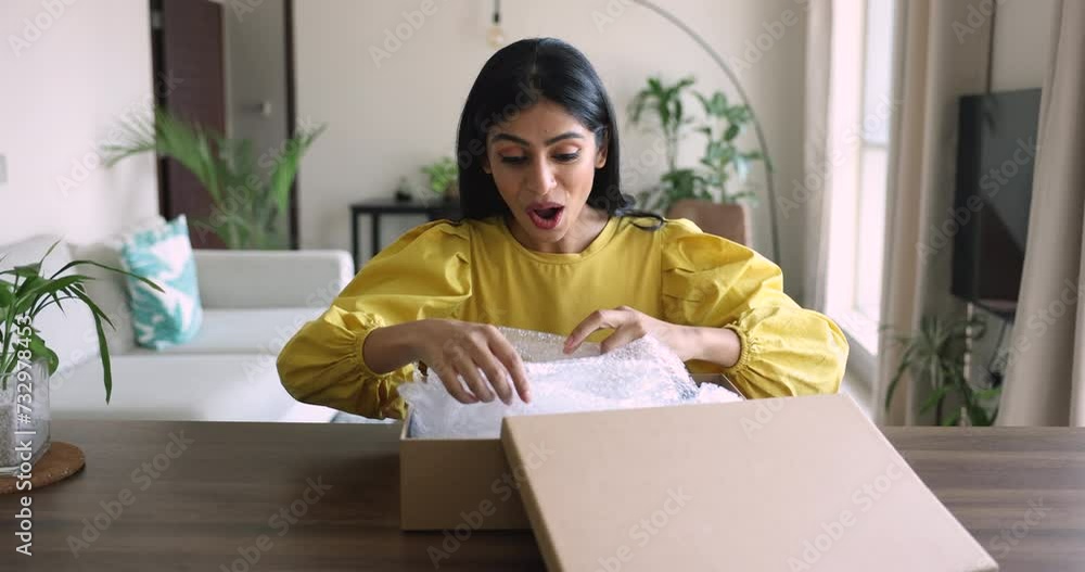 Beautiful Indian woman unpack received parcel, opening carton box enjoy ...