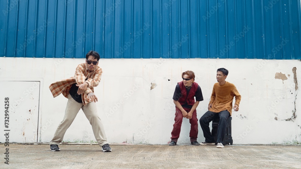 Young street dancer dancing in hip hop style with multicultural friends ...