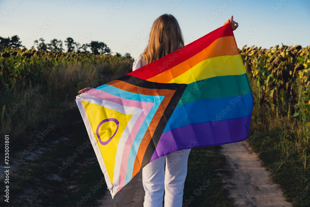Symbol of LGBTQ pride month. Young woman showing Rainbow LGBTQIA flag ...
