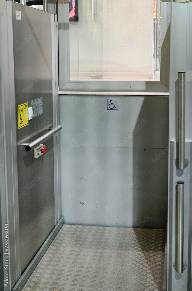 Accessible Elevator with sign. Disabled persons lift near modern ...