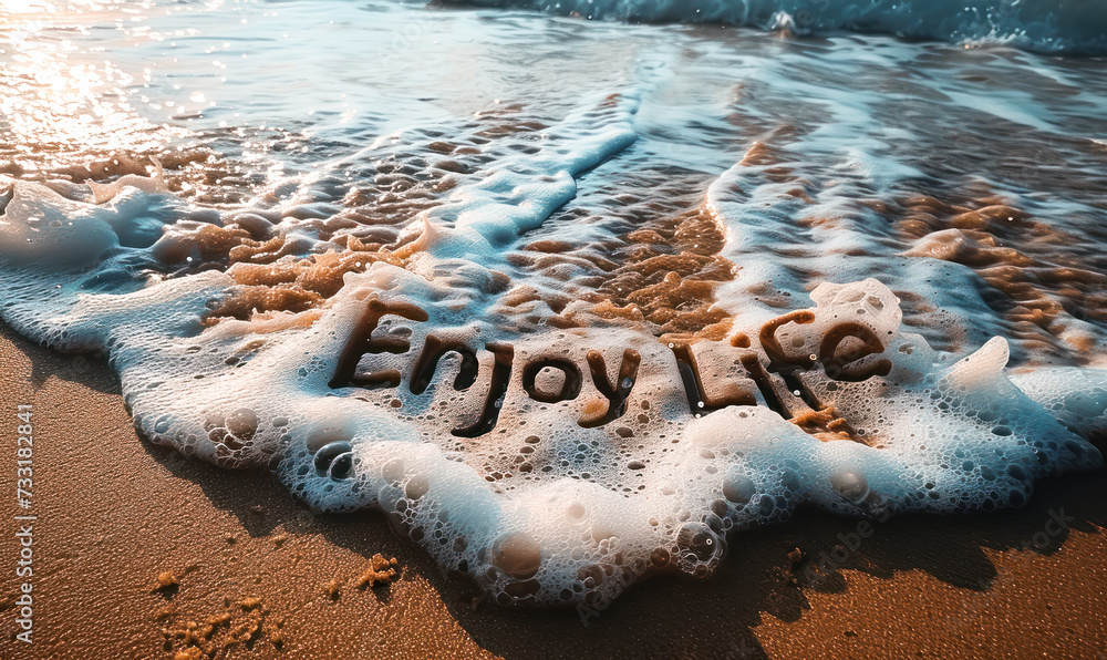 Relaxing summer vibes with Enjoy Life message handwritten in the sand ...