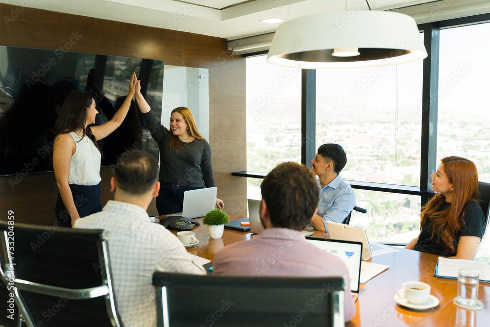 Female business partners celebrating their success and giving each ...