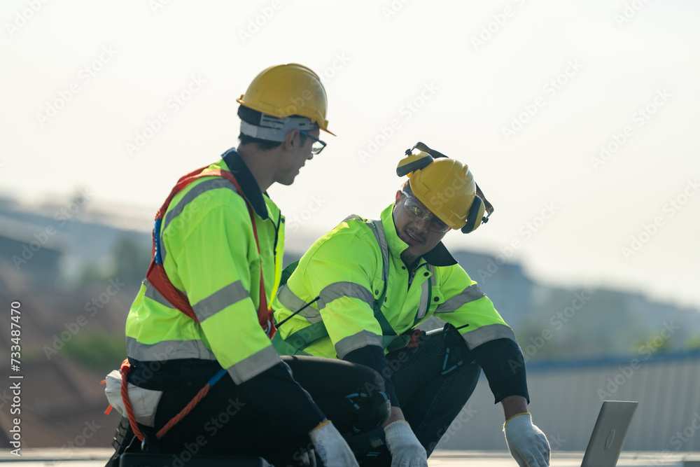 Worker Technicians are working to construct solar panels system on roof ...