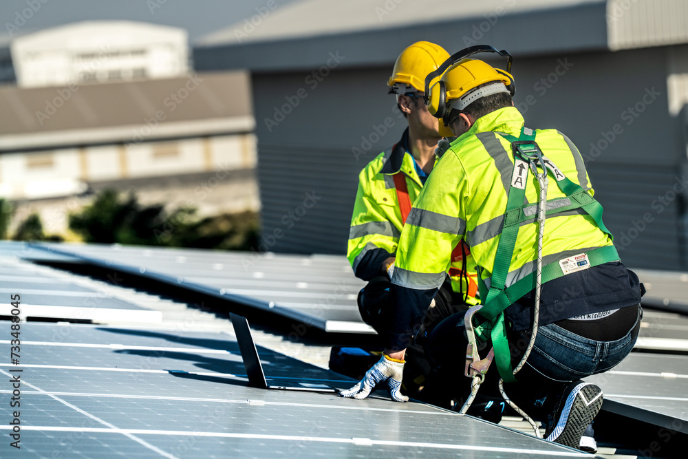 Worker Technicians are working to construct solar panels system on roof ...