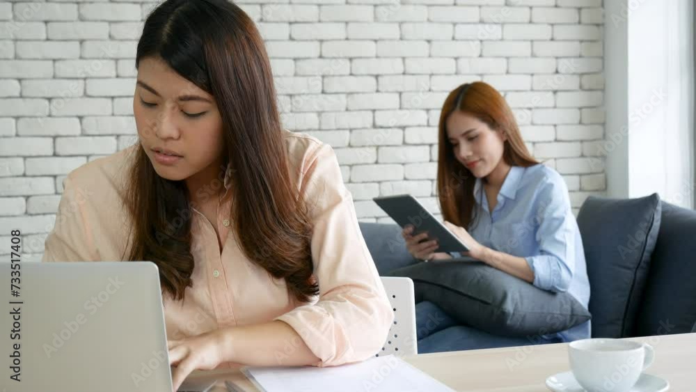 Two start up business partners enjoy good news from smartphone. Teamwork collaboration teamwork ...