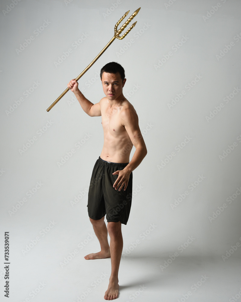 Full length portrait of fit handsome shirtless asian male model ...