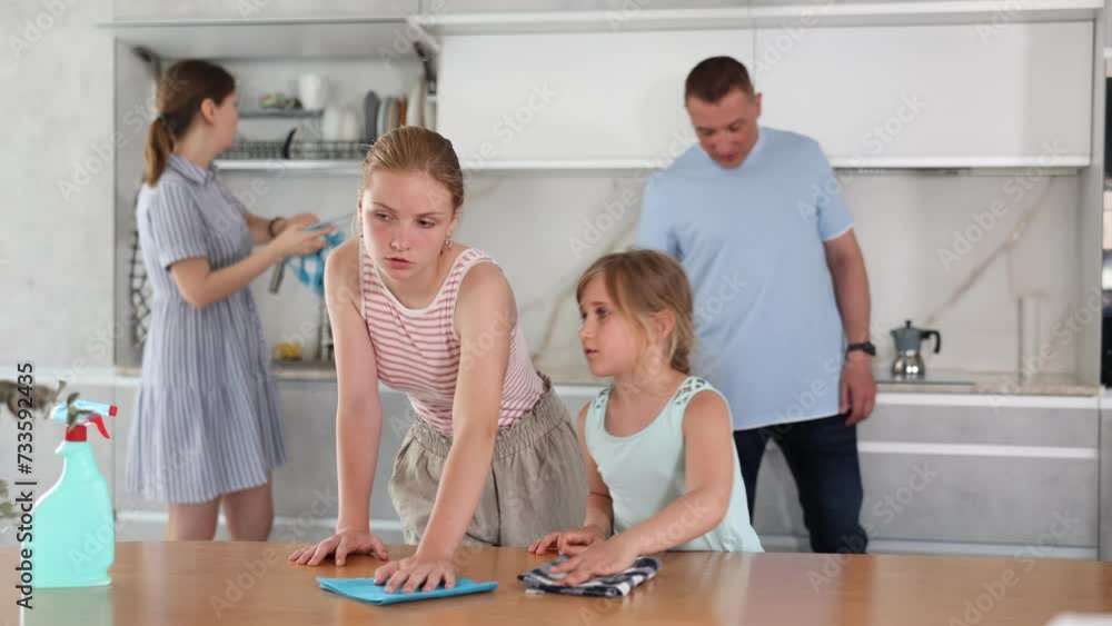 Teenage girl actively participating in household chores by assisting ...