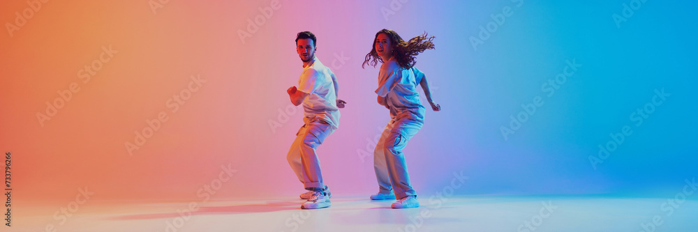 Banner. Dance duo dancing hip hop in motion against gradient t studio ...