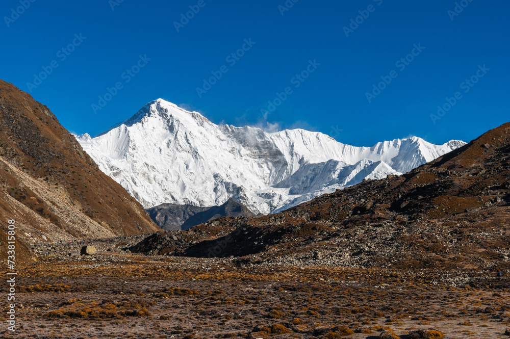 View of snow capped Mount Chumbu of the Himalayas and desert valley ...