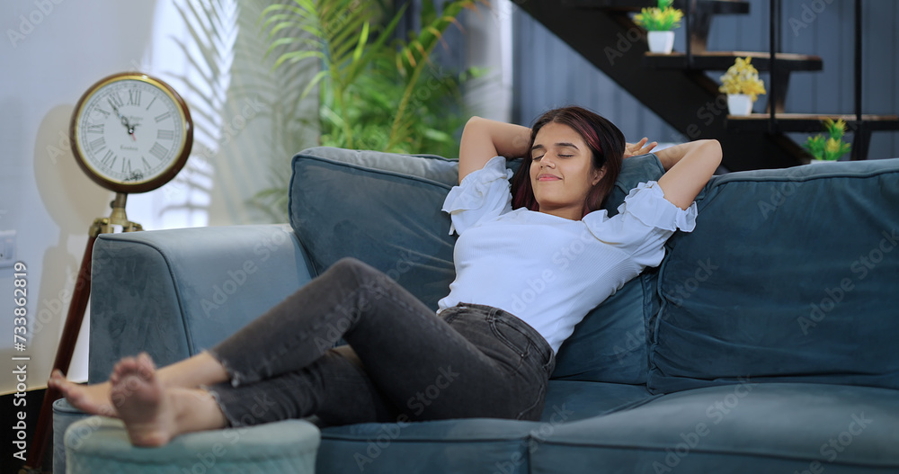 Happy Asian gen z young adult calm woman lady sitting rest relax sofa ...