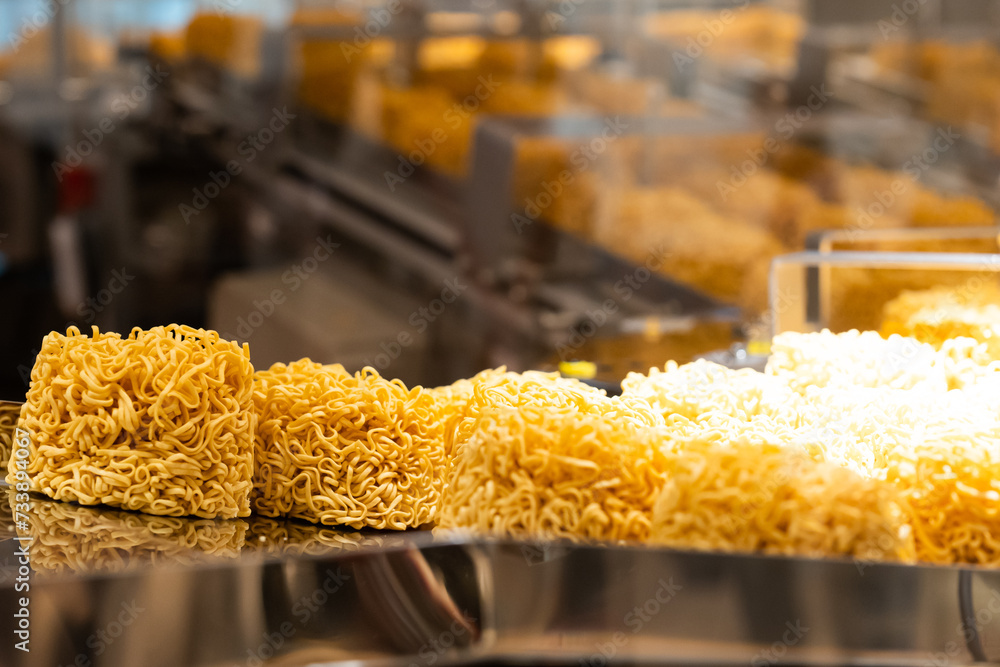 An inside glimpse of a bustling instant noodle production line ...