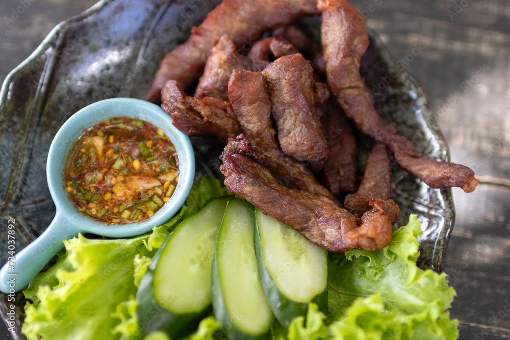 Thai fried beef jerky with Thai spicy dipping sauce (Jaew sauce). Stock ...