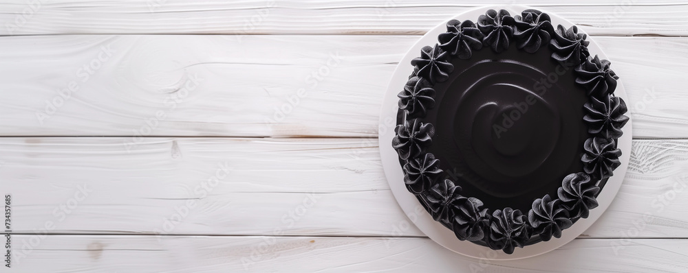 Round frosted buttercream black simple blank cake on white wood table ...