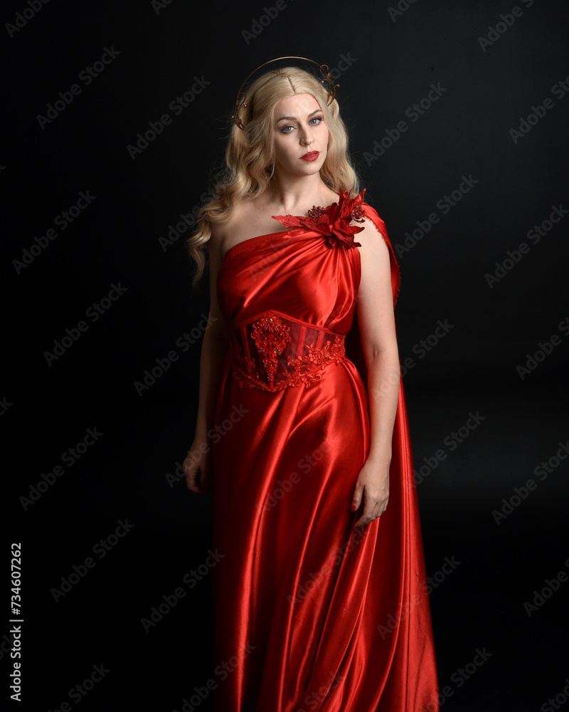 Close up portrait of beautiful blonde model wearing flowing red silk ...