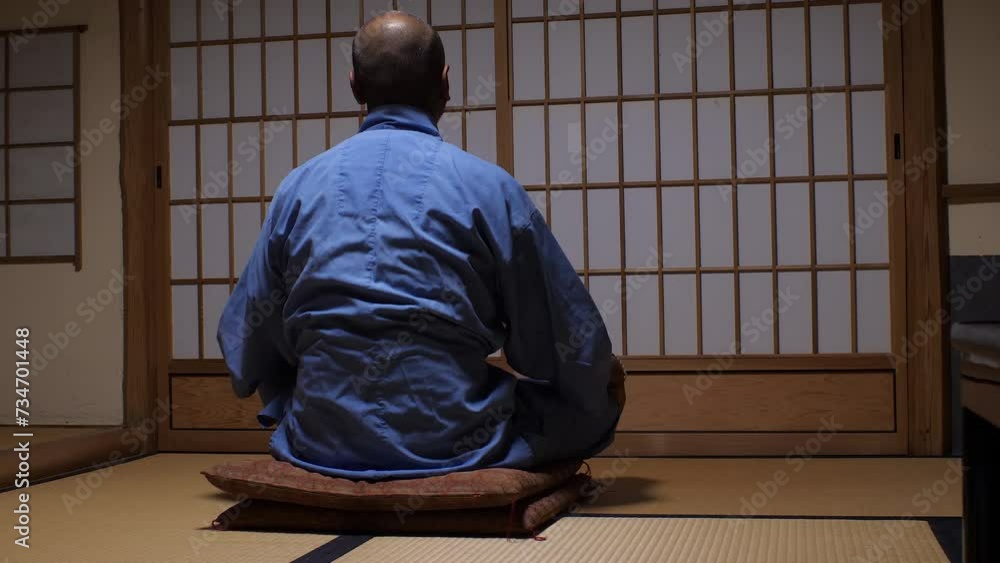 Man in traditional attire sitting serenely in a Japanese room, tatami ...