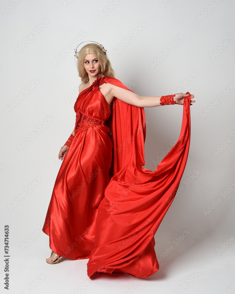 Full length portrait of blonde model dressed as ancient mythological ...