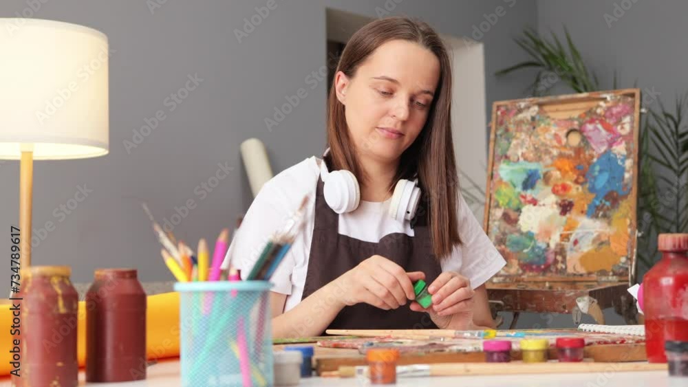 Drawing skill development. Pretty female artist painting artwork at her ...