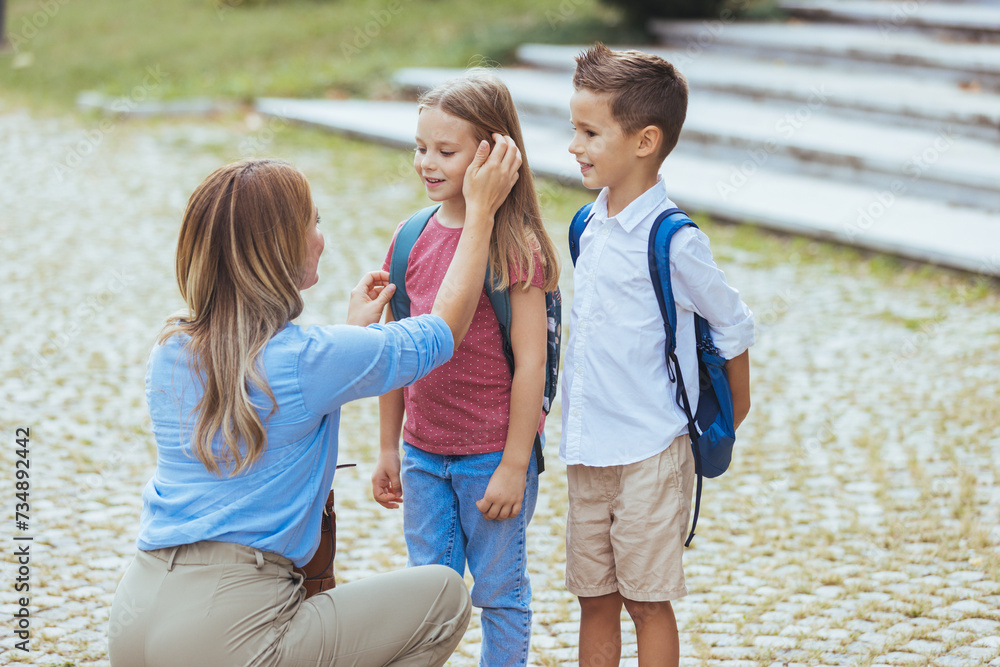 Mother Saying Goodbye To Children As They Leave For School. Thebrother ...