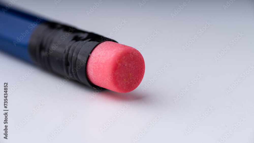 A pencil eraser stands alone against a pure white backdrop, captured in ...