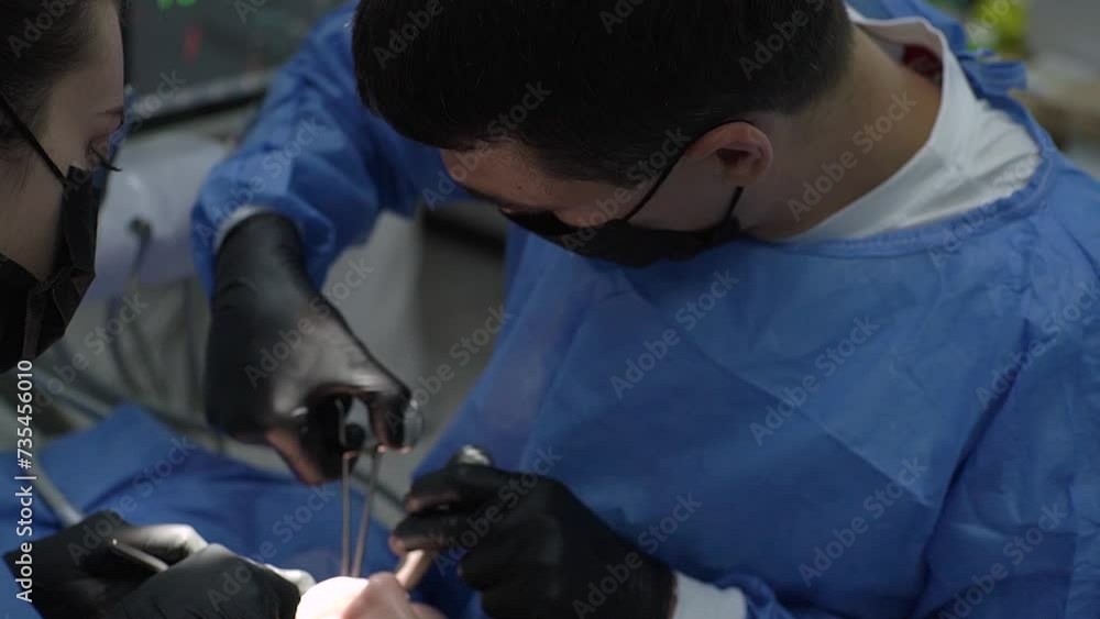 Close-up. surgeon's hands, black gloves, perform operation remove ...