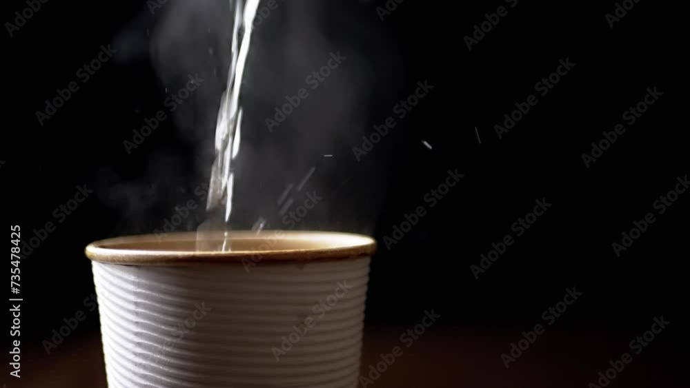 Brewing Hot Tea in a Paper Cup on a Black Background. A stream of hot ...
