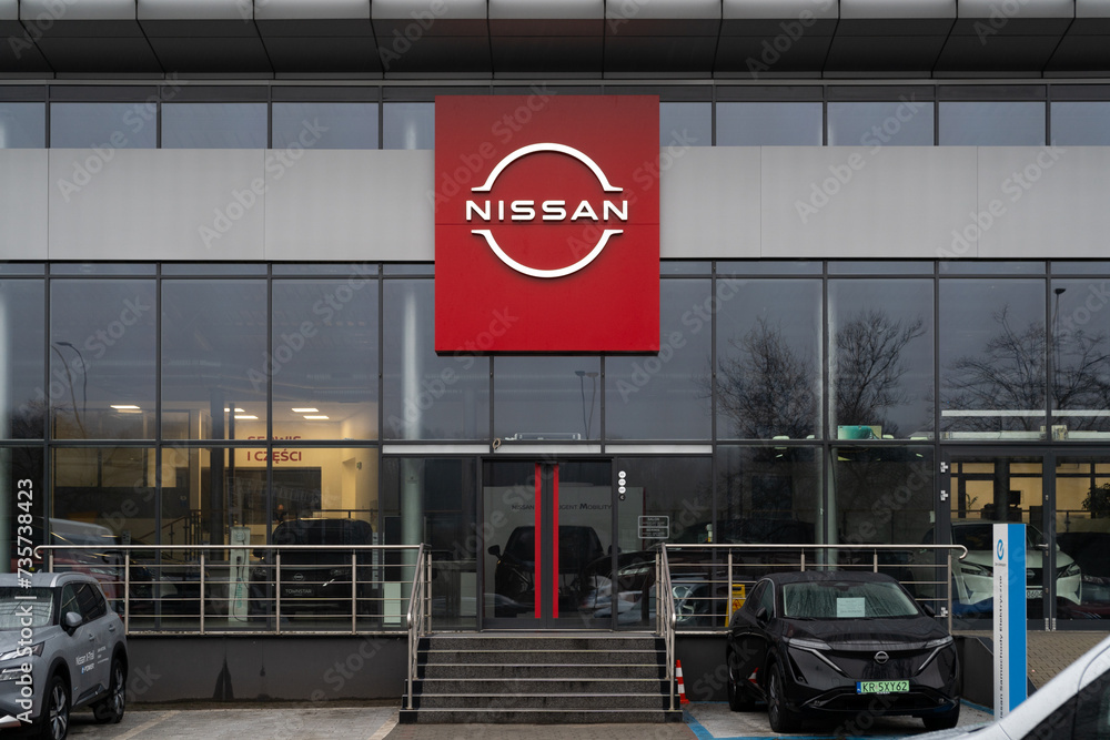 Nissan logo sign on a car dealership building. Japanese automobile ...