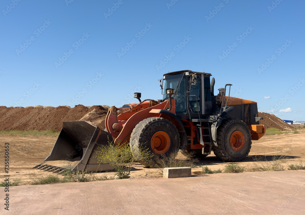 Wheel loader with a bucket during construction. Construction site with ...