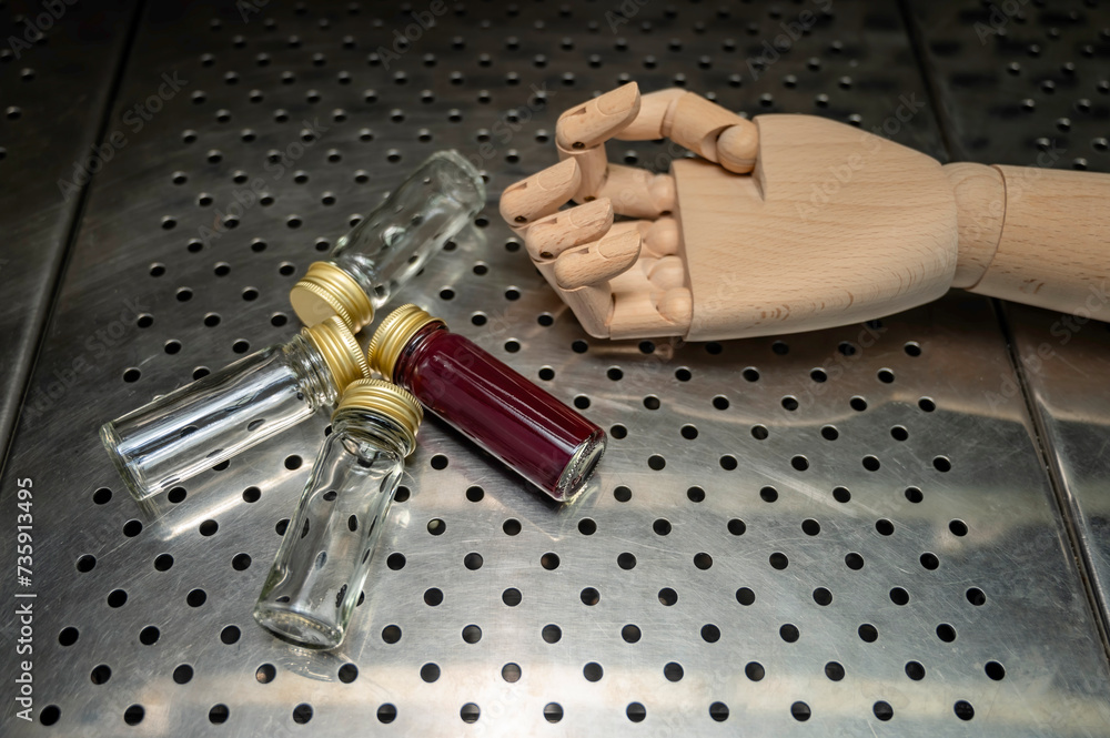 A bottle of blood specimen with another three empty glass bottles and a ...