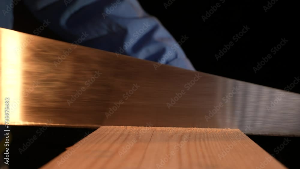 Saw in action cutting wood. Man carving wood with a saw, dust and ...