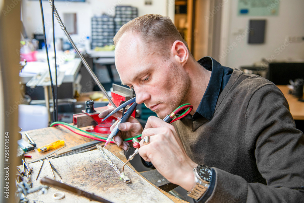 Watch maker repairing a classic watch, authentic work place. Using a ...