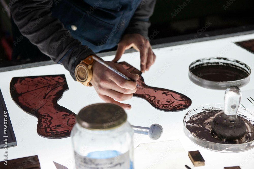 Apprentice female stained glass worker being taught lessons from ...