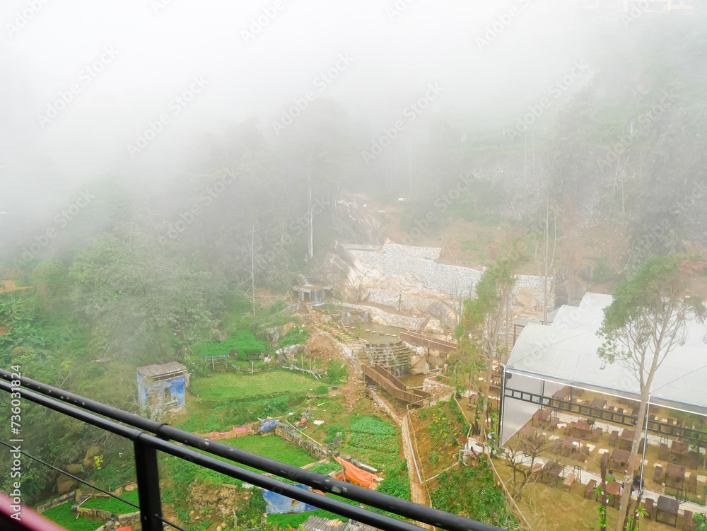 Foggy mountain landscape of Muong Hoa valley with green houses and ...