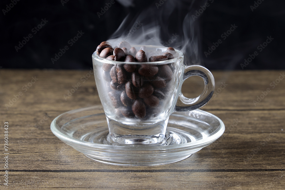 Smoke vape fog flowing out of transparent glass coffee cup filled with ...