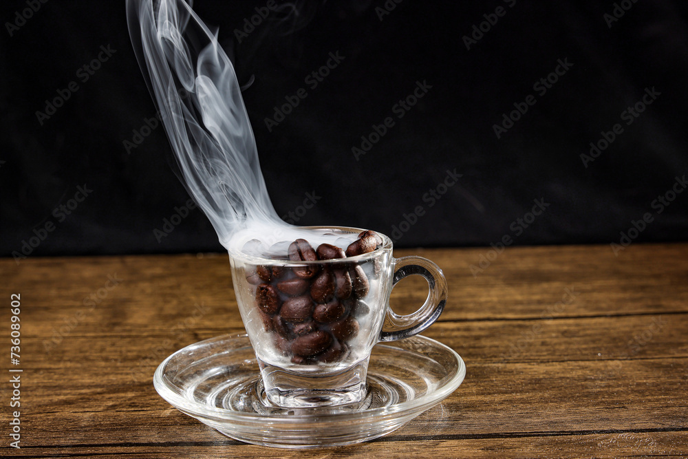 Smoke vape fog flowing out of transparent glass coffee cup filled with ...
