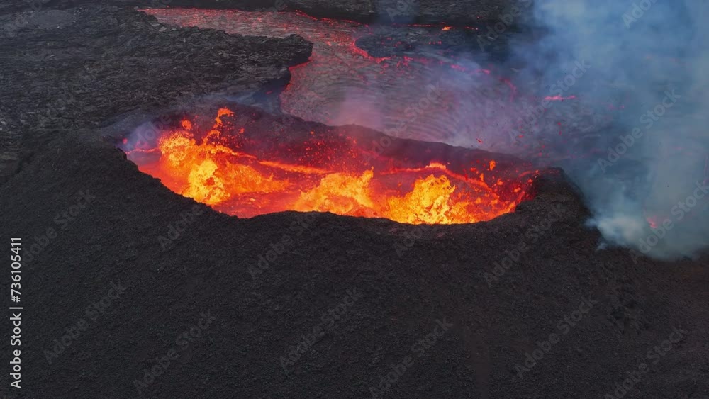 Aerial drone fly view over active volcanic crater eruption. Hot lava ...