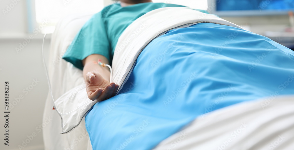 Sick man is lying on hospital bed under dropper. Treatment an addict in ...