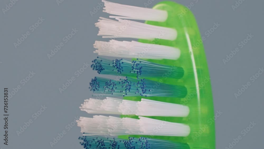 A showcasing of bright tricolor toothbrush in a vertical position ...