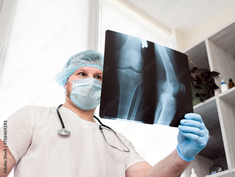 A doctor with a stethoscope, in a medical uniform in a clinic, a ...