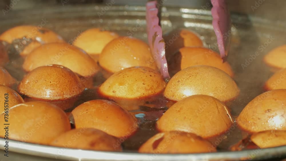 Chinese century eggs or tea egg in boiling water close-up. Chinese egg ...