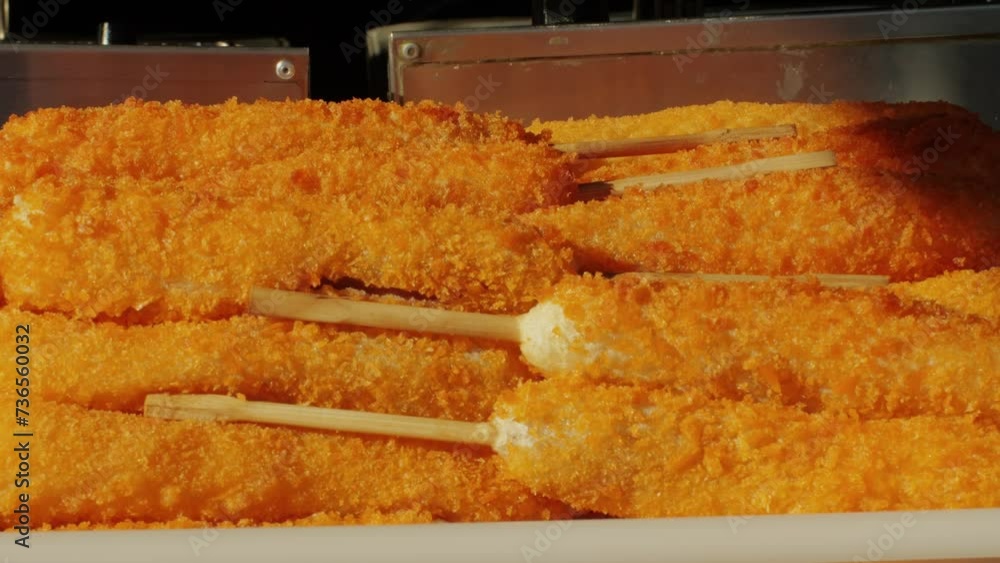 Cooking corn dogs in boiling oil close-up. Traditional asian corndog ...